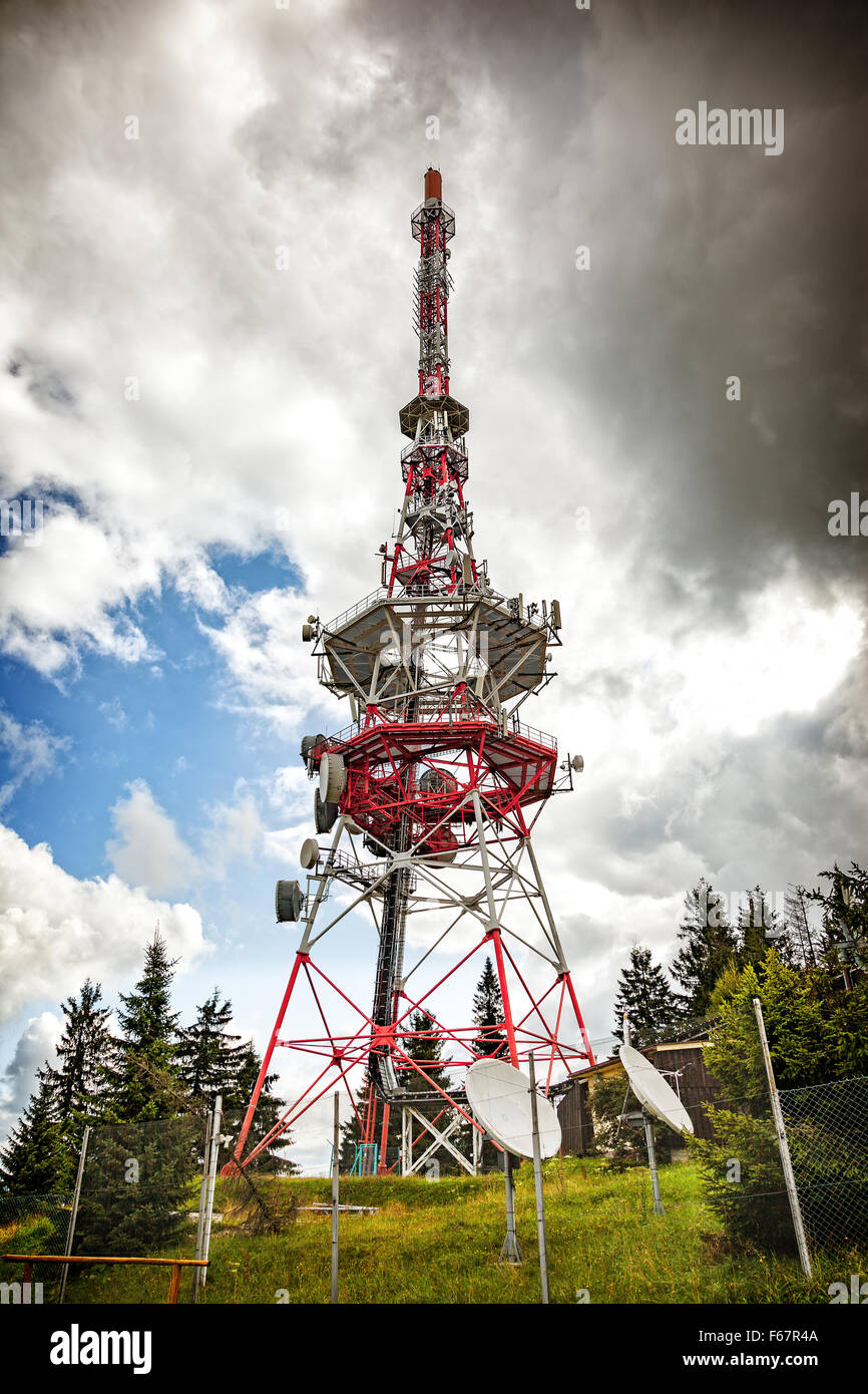 Telecommunications tower with dark clouds at background Stock Photo - Alamy