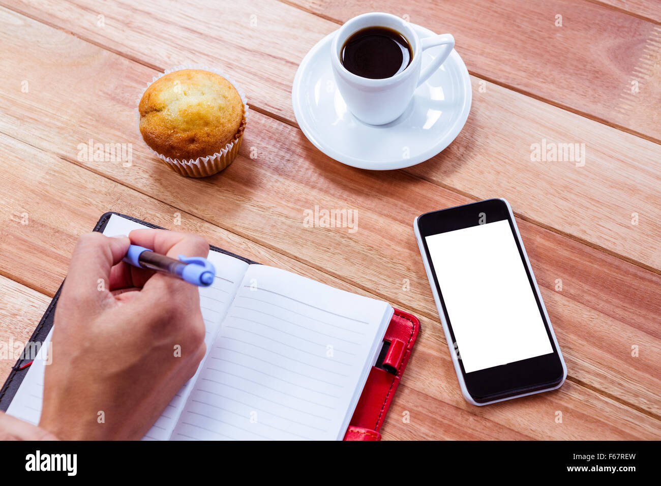 Overhead of feminine hands writing on agenda Stock Photo - Alamy