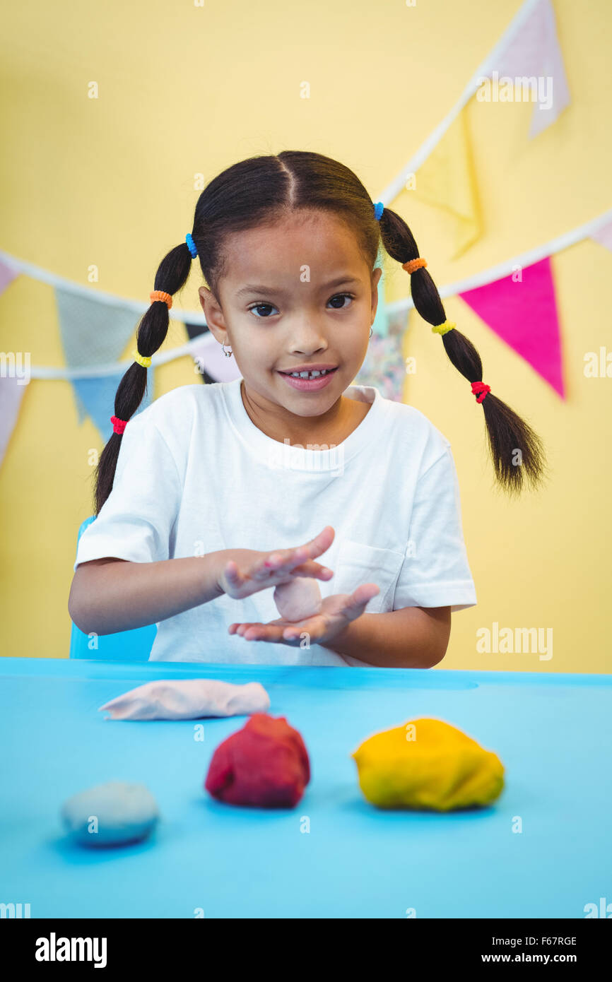 Happy girl with modelling clay Stock Photo - Alamy