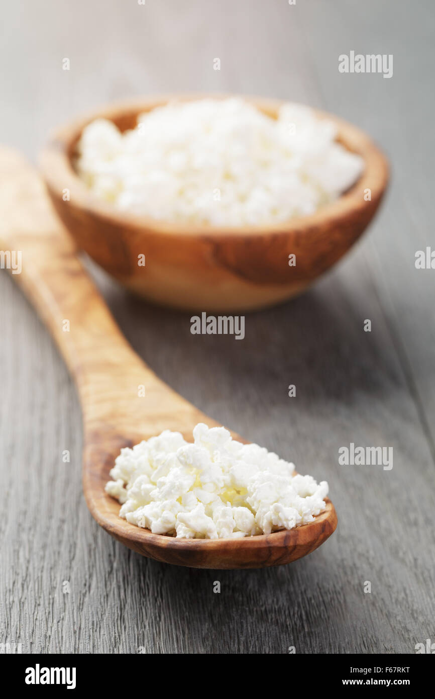 fresh cottage cheese in a wood bowl on a wooden table Stock Photo - Alamy