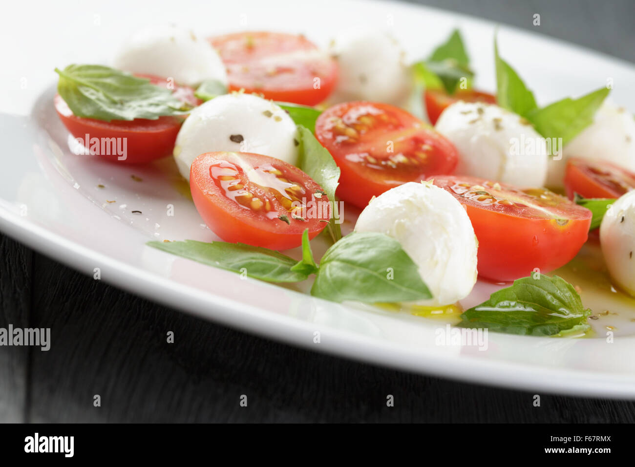 caprese salad with mini mozzarella balls and tomatoes Stock Photo - Alamy