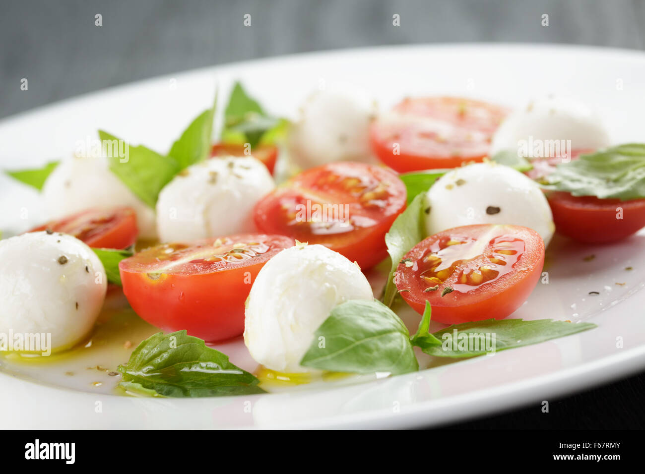 caprese salad with mini mozzarella balls and tomatoes Stock Photo - Alamy