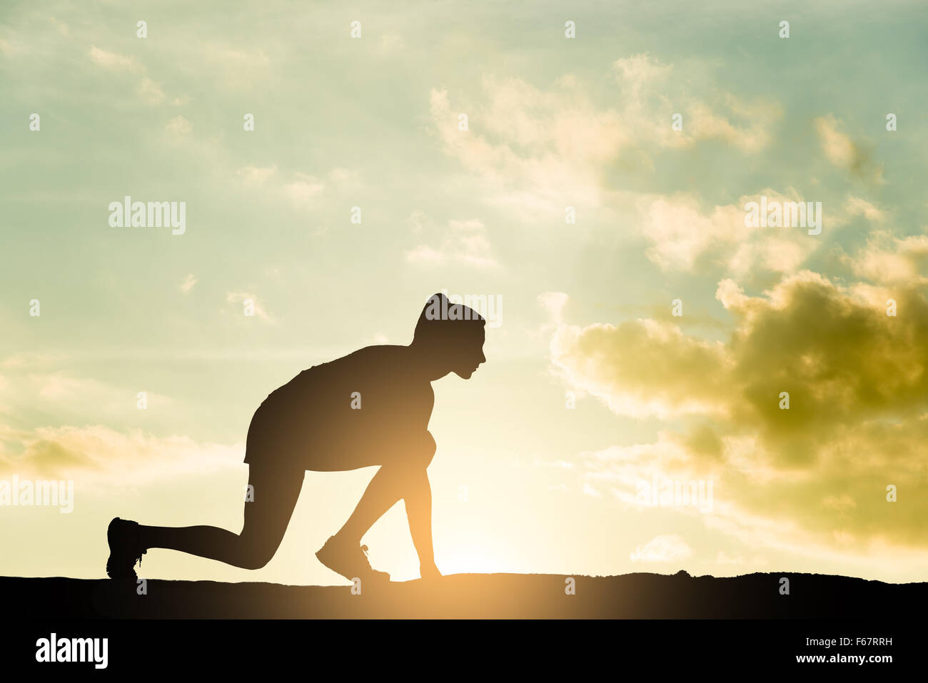 Athlete runner woman starting run at sunset Stock Photo - Alamy
