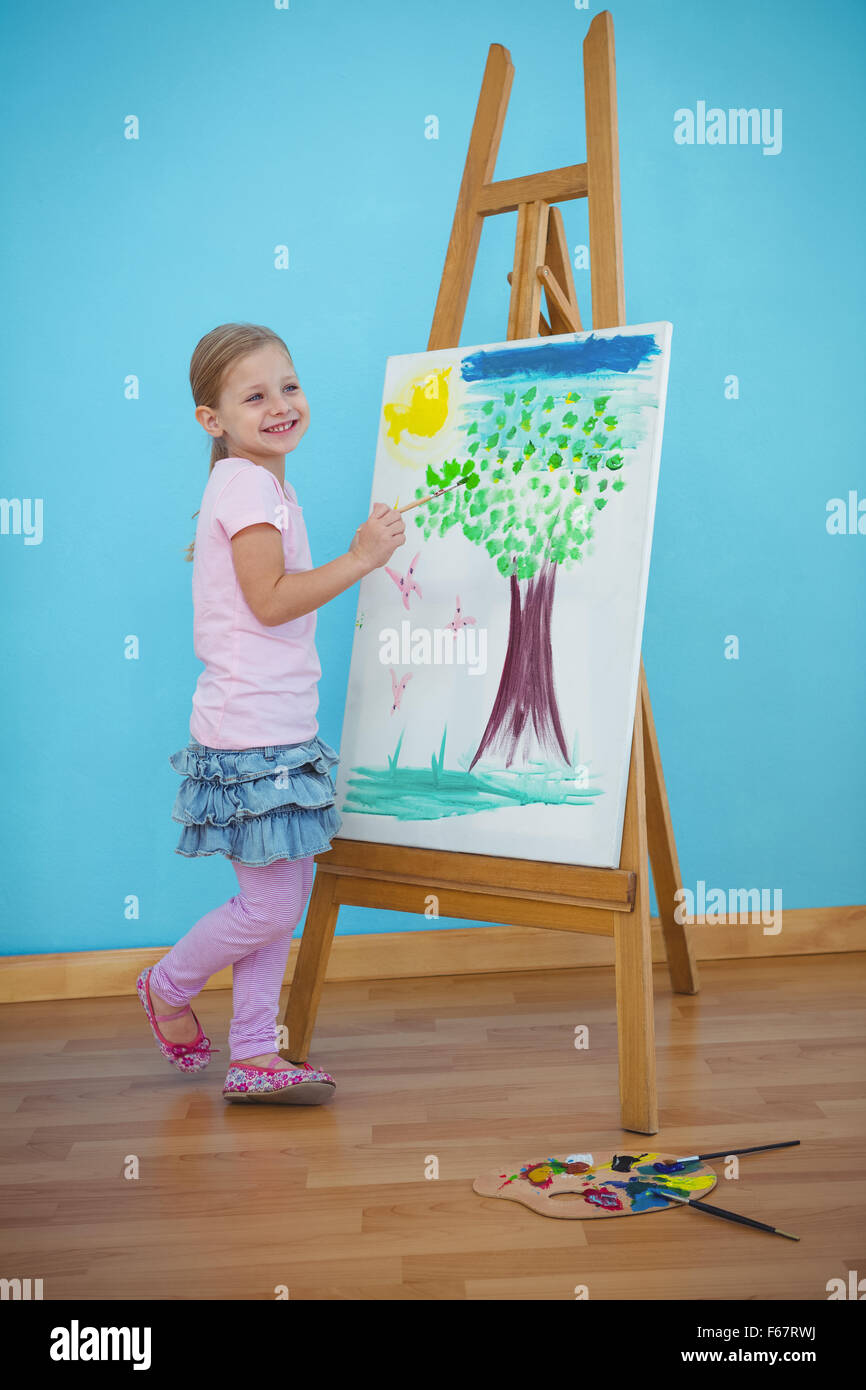 Smiling girl beside her picture Stock Photo - Alamy