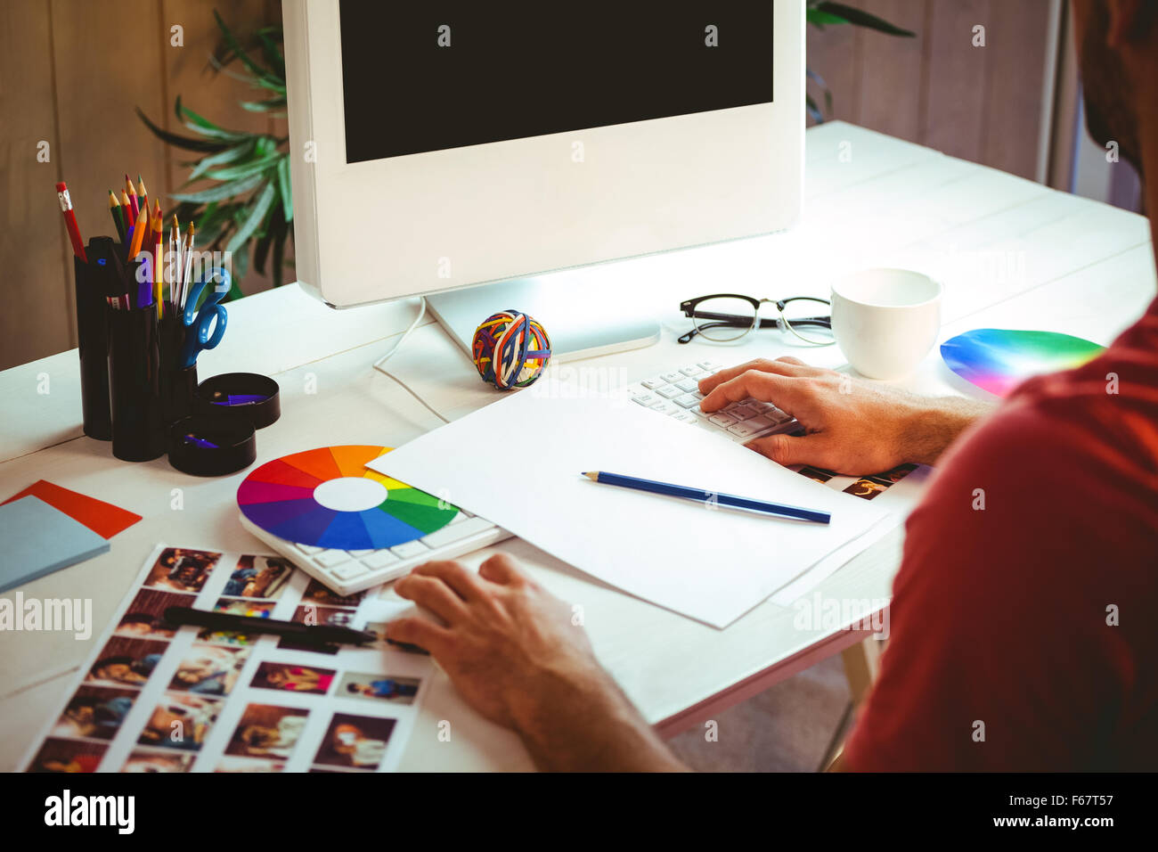 Man using his computer at his desk Stock Photo - Alamy