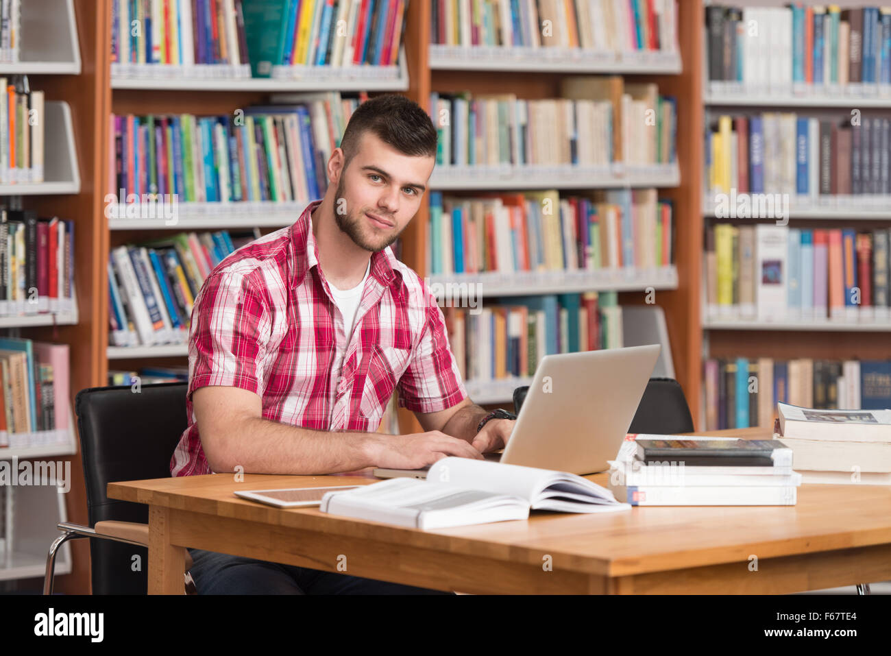 In The Library - Handsome Male Student With Laptop And Books Working In ...