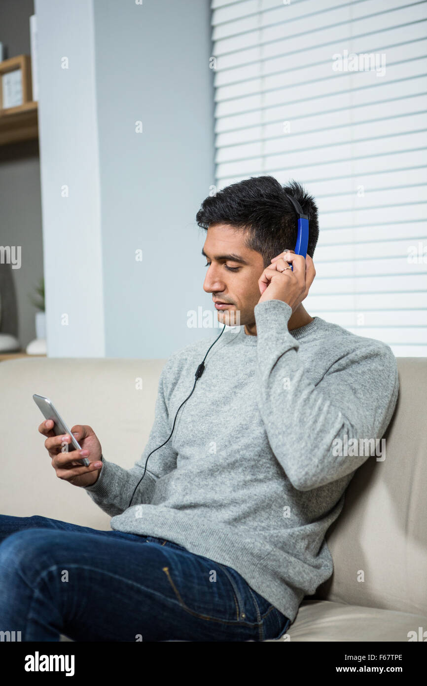 Casual happy man listening music Stock Photo - Alamy