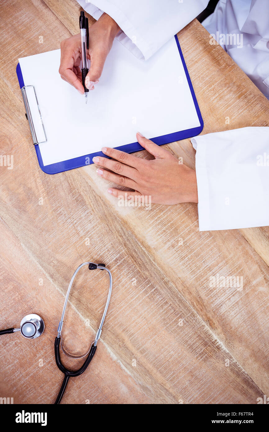 Doctor writing on clipboard Stock Photo - Alamy