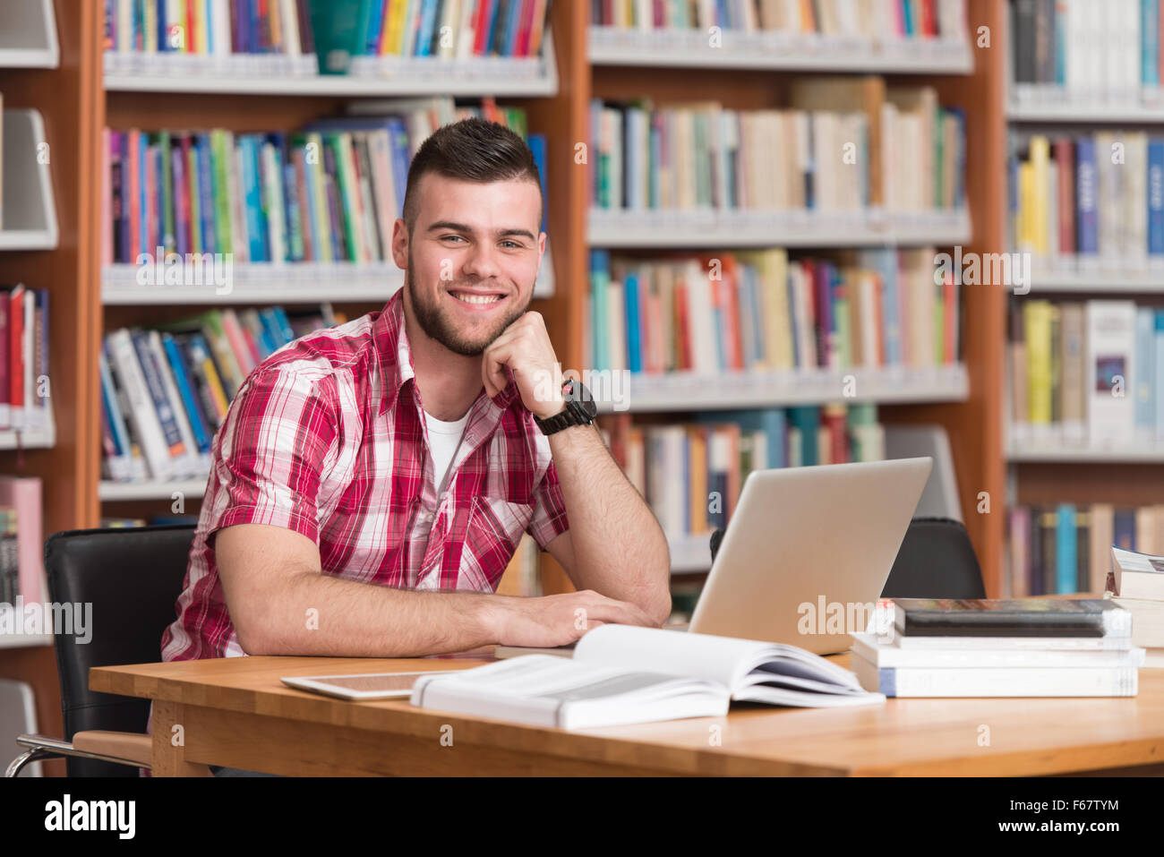 In The Library - Handsome Male Student With Laptop And Books Working In ...
