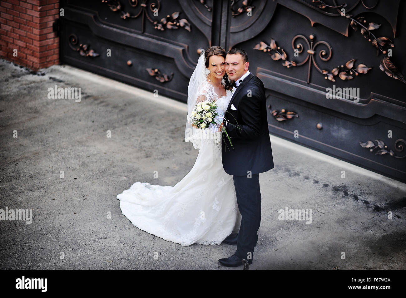 wedding couple near wrought iron gates Stock Photo - Alamy