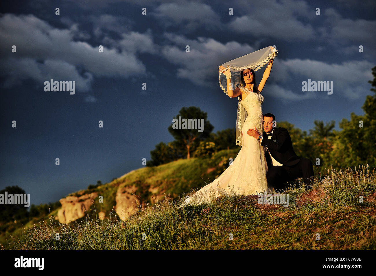 Cloudy sky and wedding couple Stock Photo - Alamy