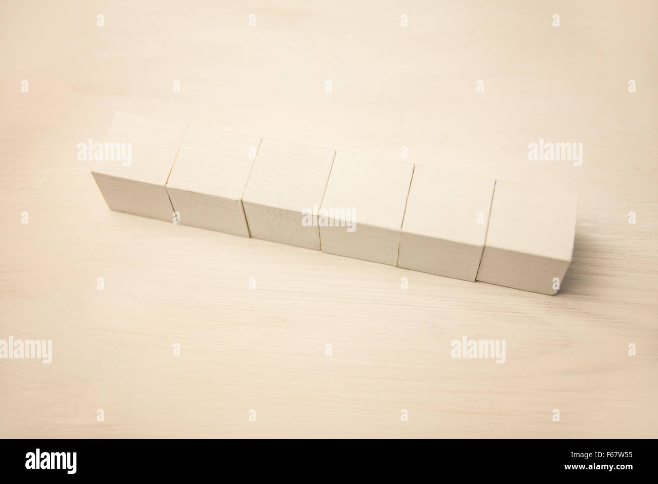 Row of blocks on table Stock Photo - Alamy