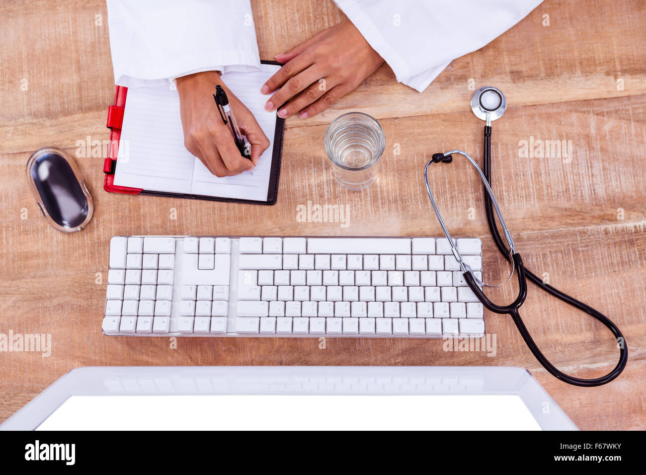 Doctor writing on her diary Stock Photo - Alamy