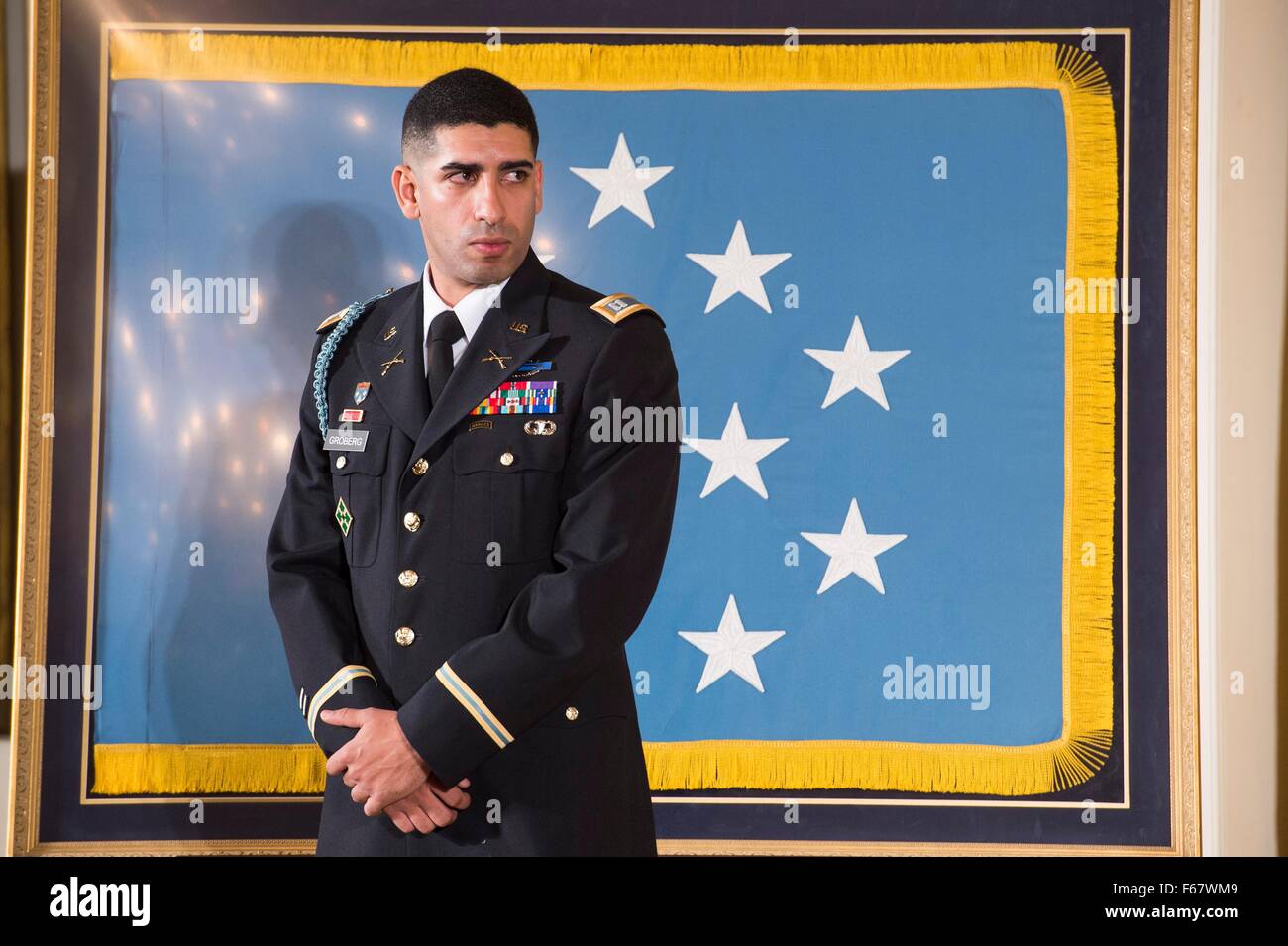 Retired U.S. Army Capt. Florent Groberg looks on as President Barack ...