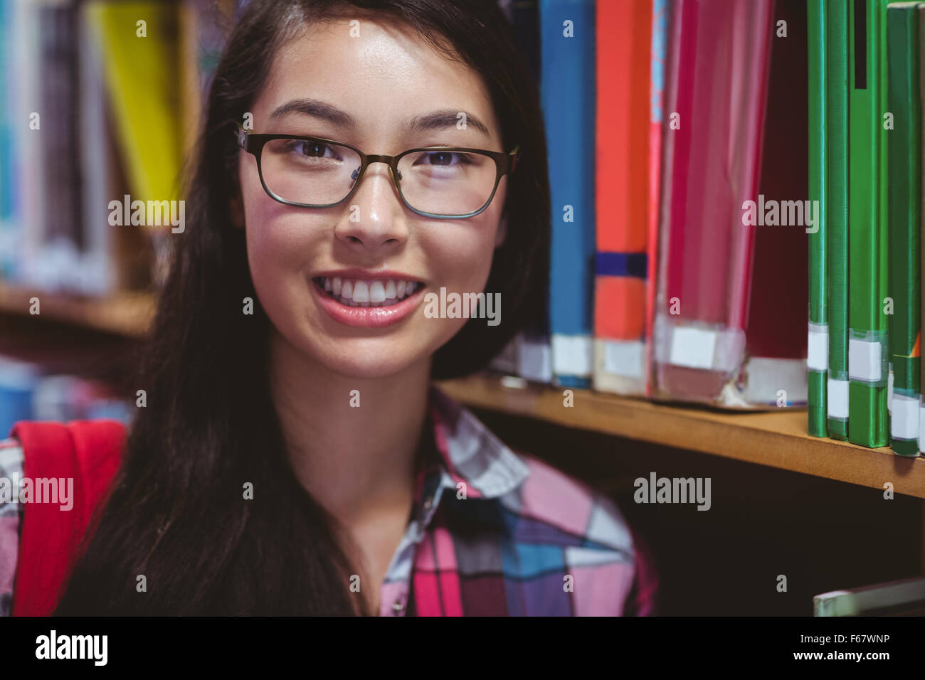 Smiling student in library Stock Photo - Alamy