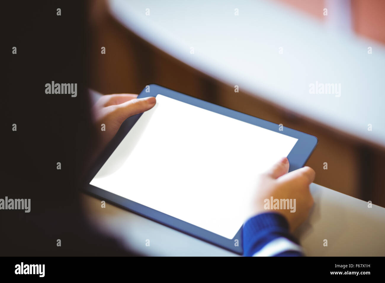 Student in lecture hall using tablet Stock Photo - Alamy