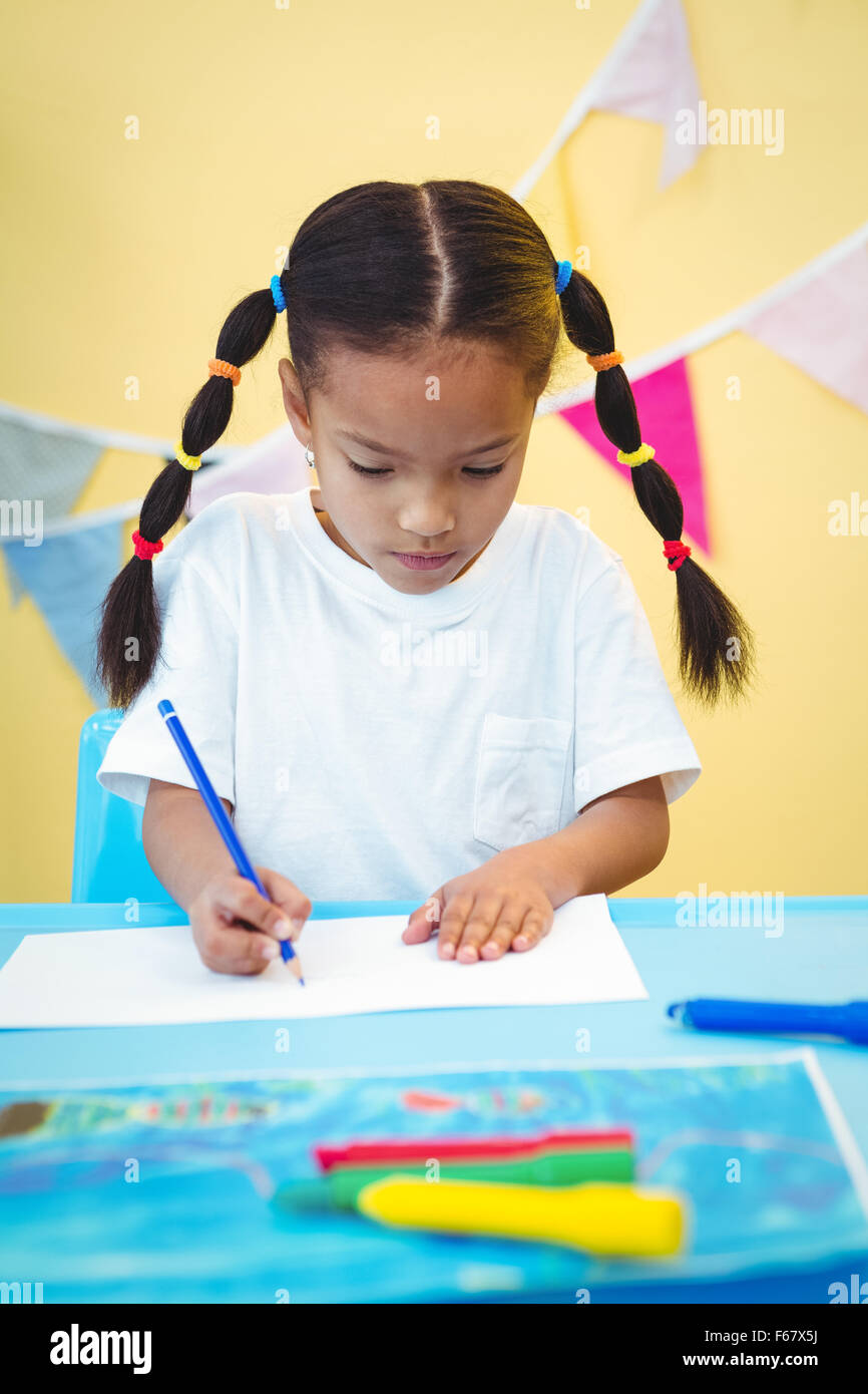 Focused girl drawing on paper Stock Photo - Alamy