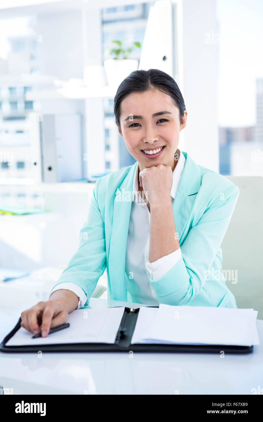 Smiling businesswoman notes desk hi-res stock photography and images ...