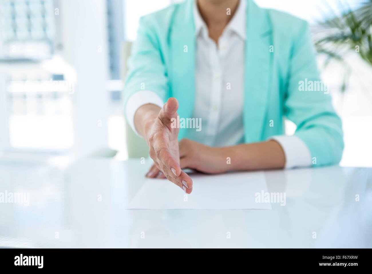 Businesswoman offering a handshake Stock Photo - Alamy