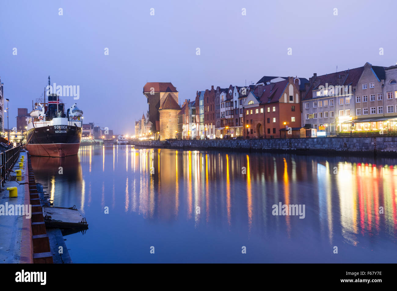 Waterfront tenements medieval crane and SS Sołdek museum ship reflected ...