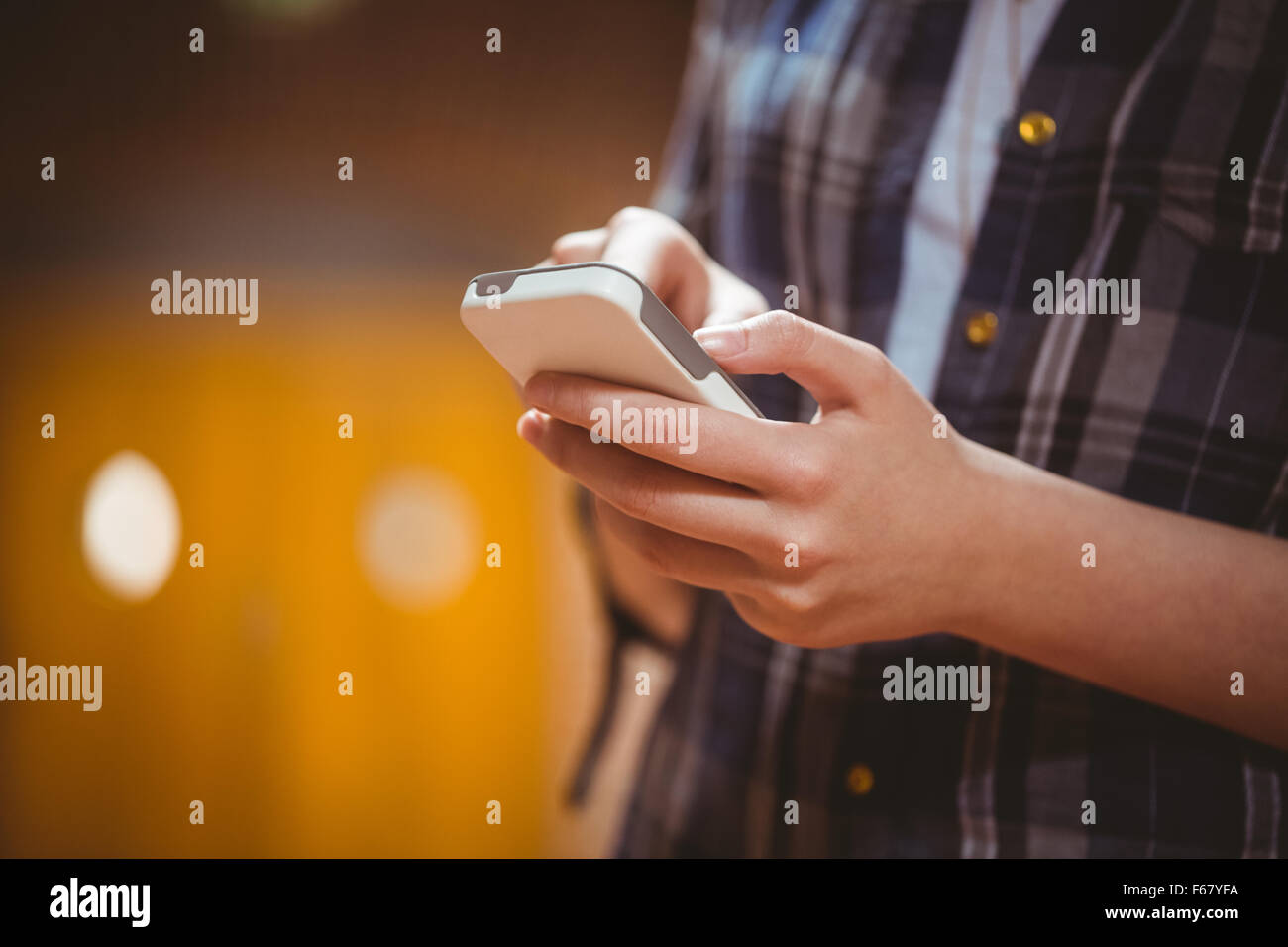 Standing student using smartphone Stock Photo - Alamy