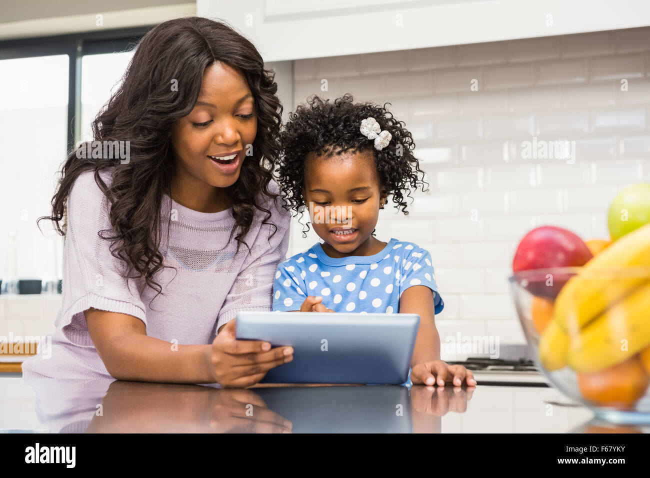 Mother and daughter using tablet pc Stock Photo - Alamy