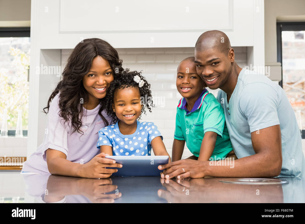 Happy family using tablet Stock Photo - Alamy