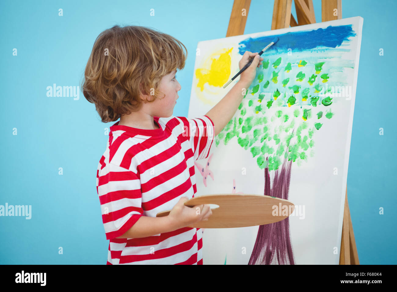 Happy boy painting his picture Stock Photo - Alamy