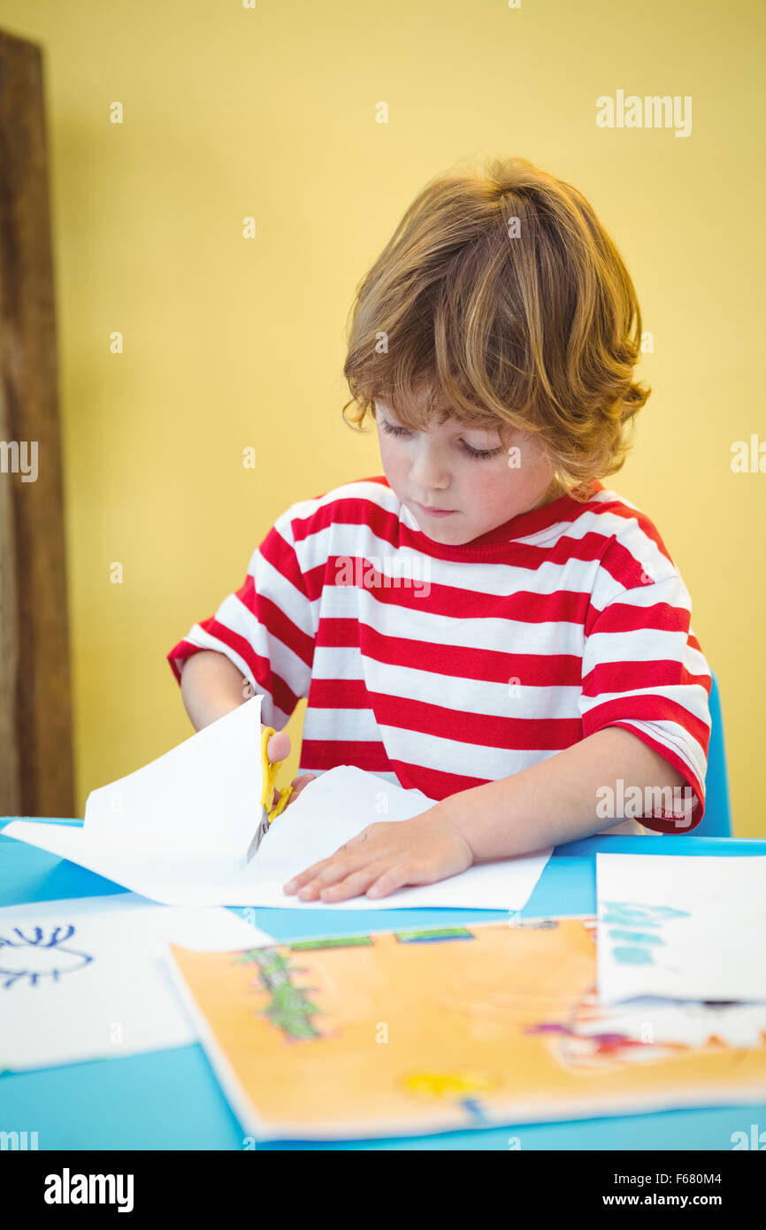 Boy using scissors to cut paper Stock Photo - Alamy