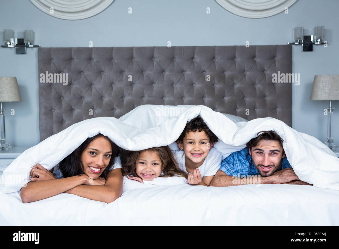 Woman under blanket happy bed hi-res stock photography and images - Alamy