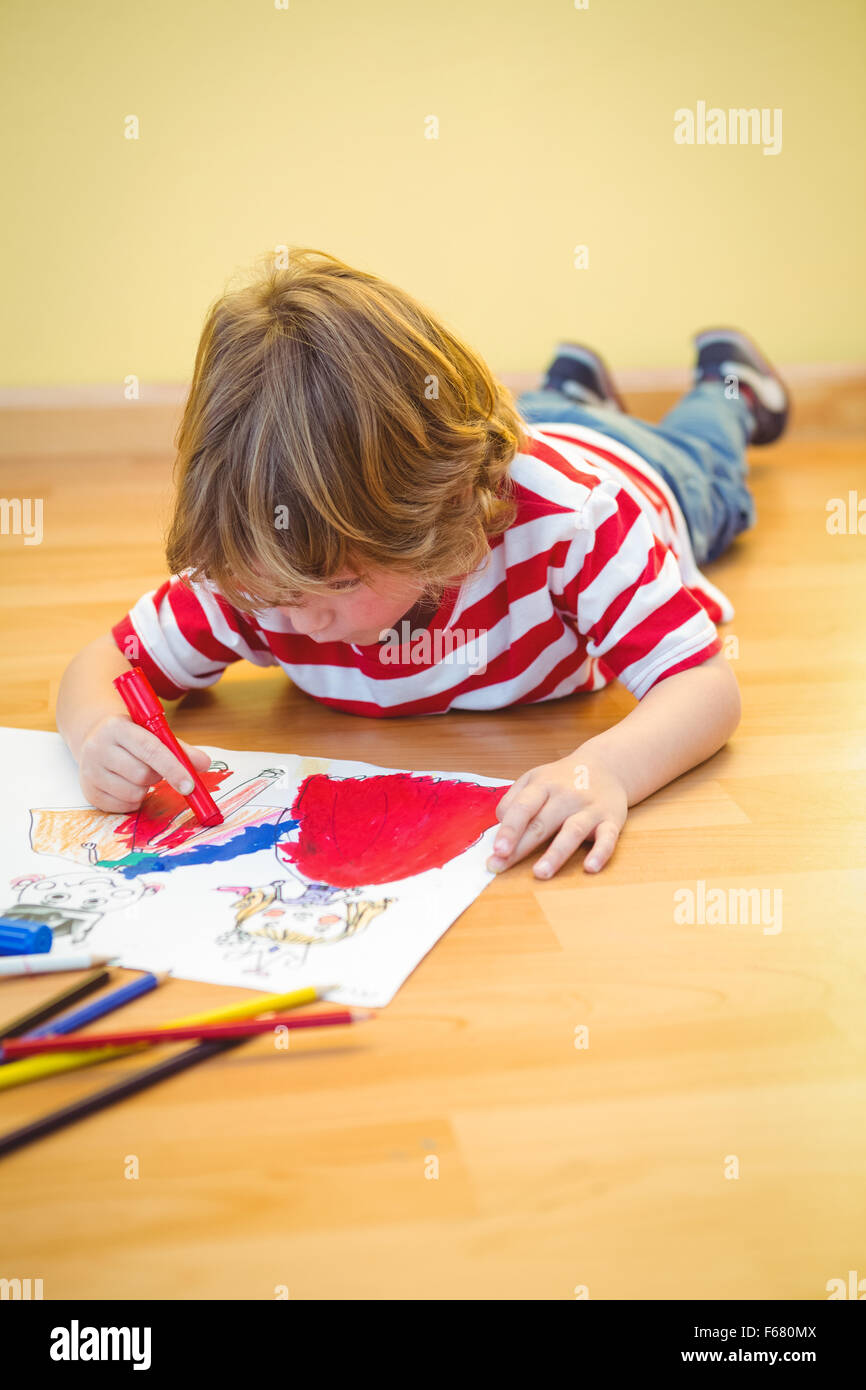 Boy lying on the ground Stock Photo - Alamy