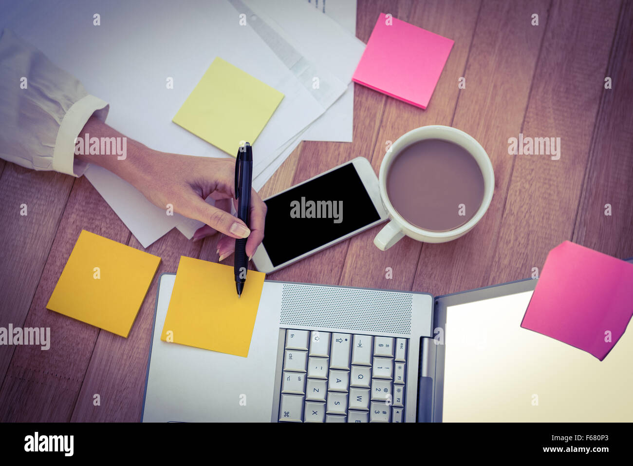 Cropped image of woman writing on sticky notes Stock Photo - Alamy