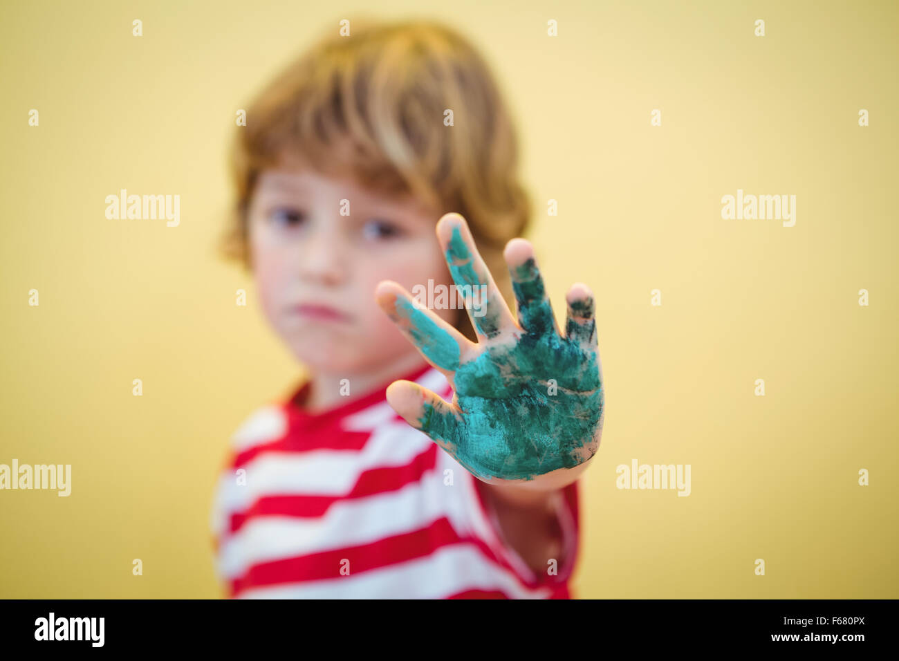 Boy holding up his paint covered hand Stock Photo - Alamy