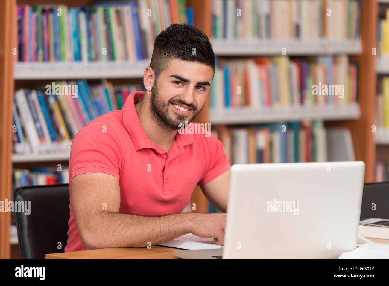In The Library - Handsome Arabic Male Student With Laptop And Books ...