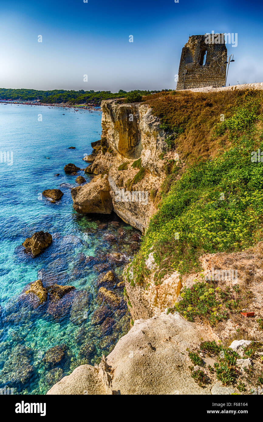 Ruins of ancient watchtower on rocky cove on the coast of Salento in ...