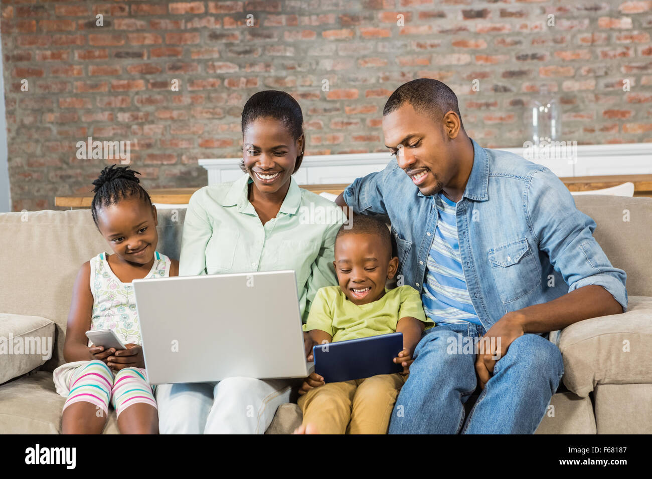 Happy family using technology together Stock Photo - Alamy