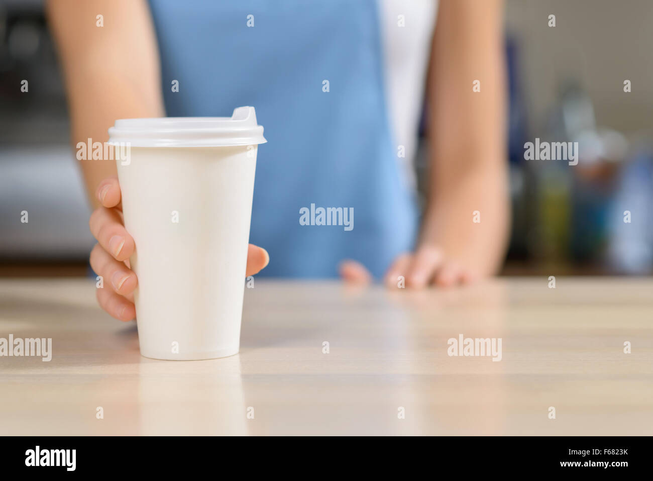 Pleasant waitress standing at a counter Stock Photo - Alamy