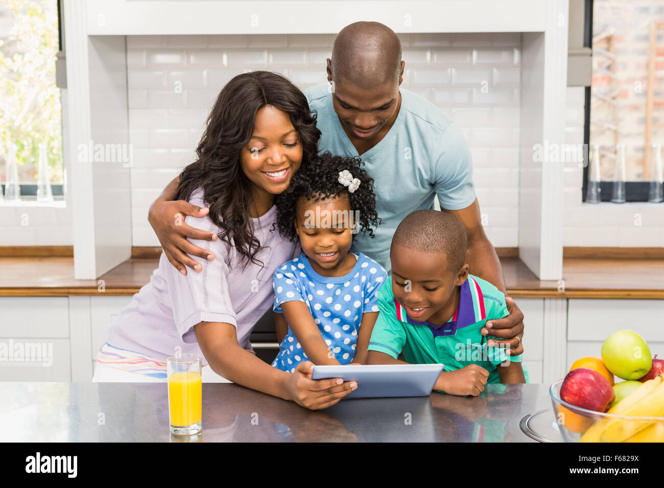 Happy family using tablet Stock Photo - Alamy