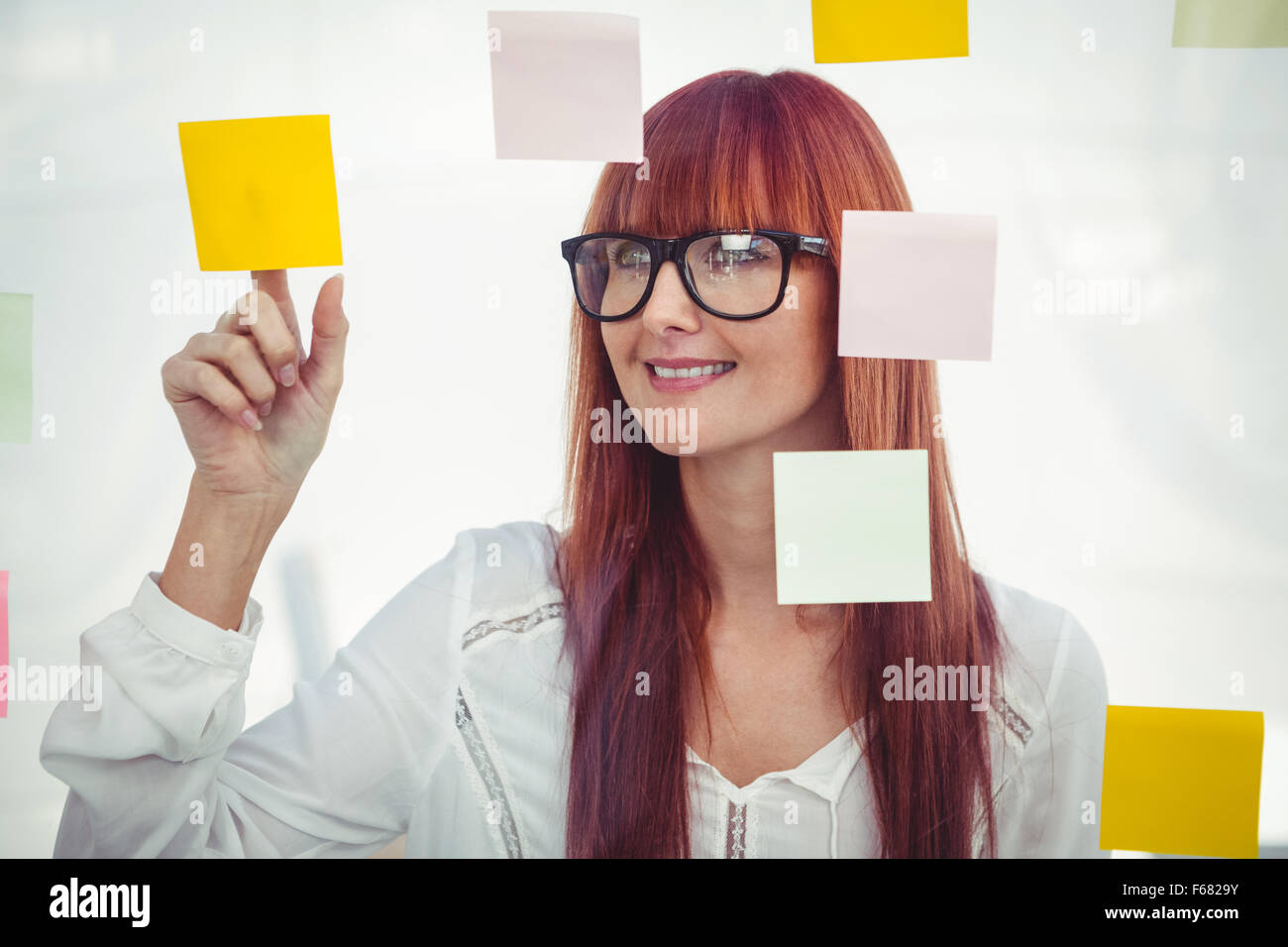 Attractive hipster woman pointing sticky notes Stock Photo - Alamy