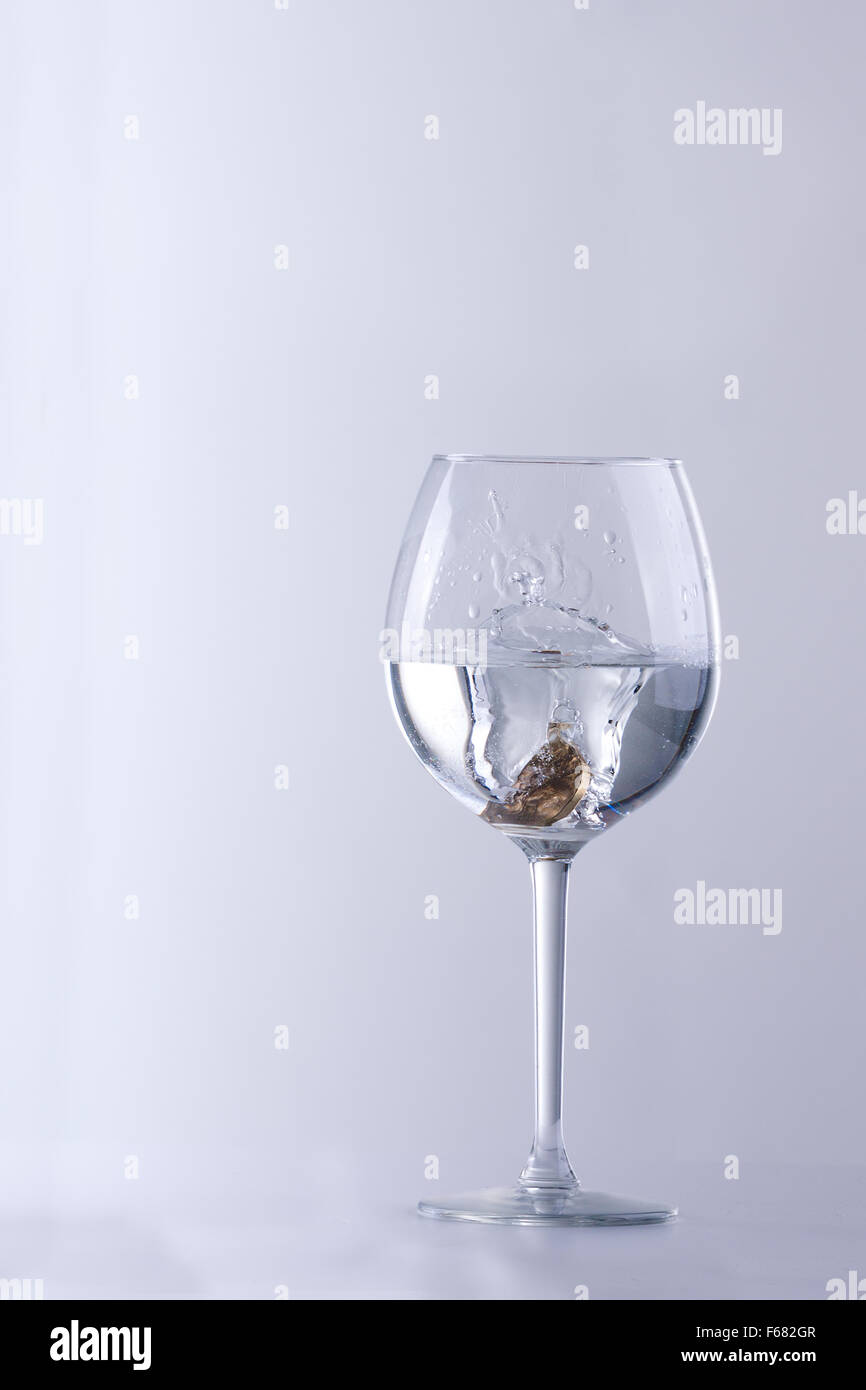 Coins fall water glass hi-res stock photography and images - Alamy