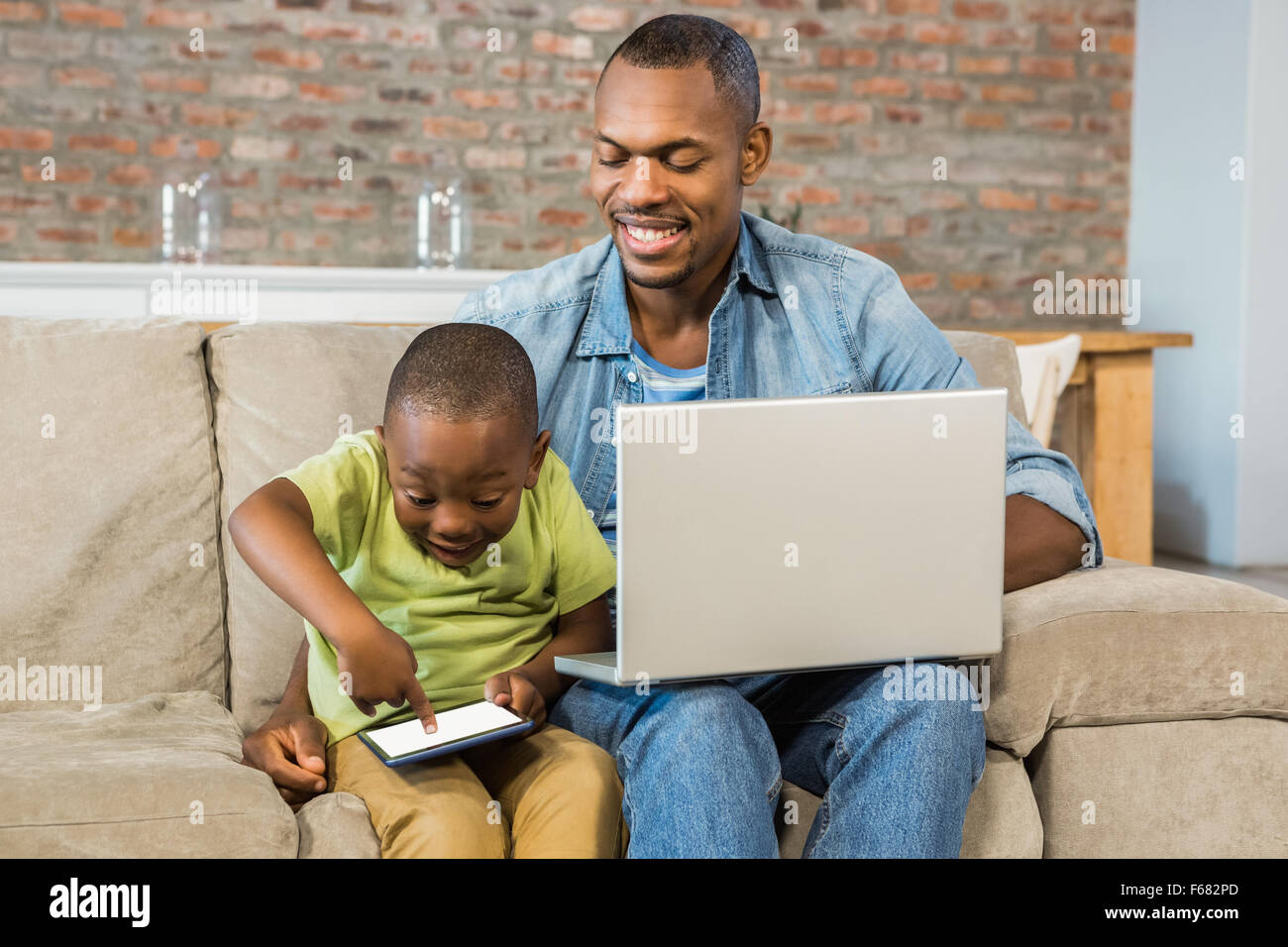 Happy family using technology together Stock Photo - Alamy