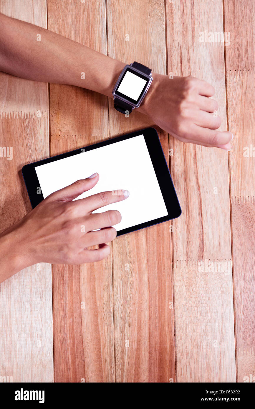Feminine hands with smartwatch using tablet Stock Photo - Alamy