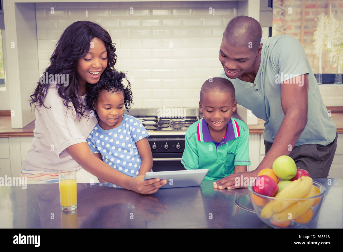 Happy family using tablet Stock Photo - Alamy
