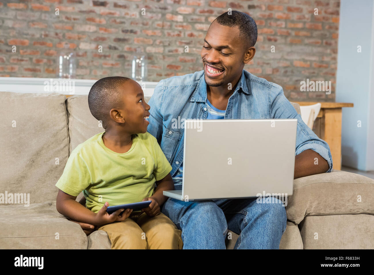 Happy family using technology together Stock Photo - Alamy