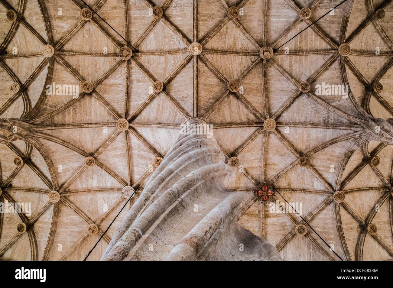 a view straight from the bottom of a intricate roof and the column that ...