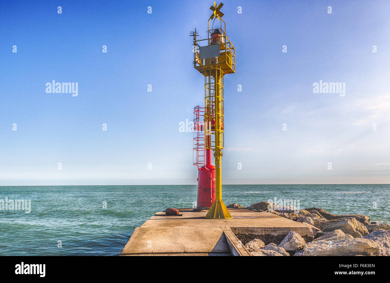 red and yellow lighthouses on a pier on the Adriatic Sea Stock Photo ...
