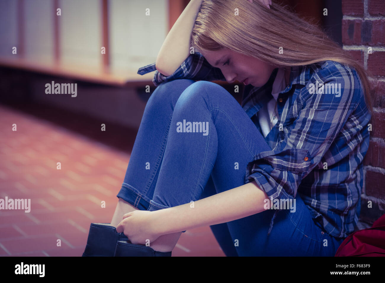Sad girl sitting against wall hi-res stock photography and images - Alamy