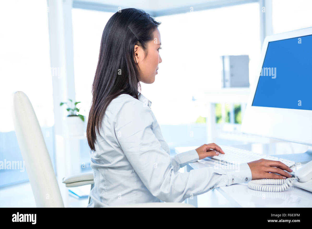 Attractive businesswoman using computer Stock Photo - Alamy