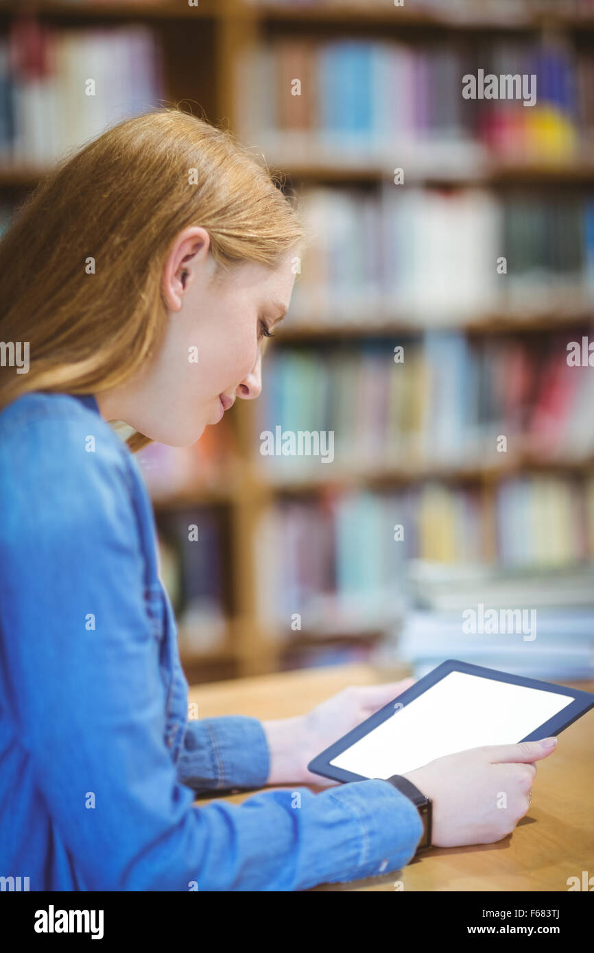 Student with smartwatch using tablet in library Stock Photo - Alamy