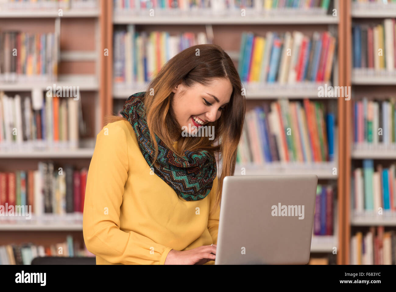In The Library - Beautiful Female Student With Laptop And Books Working ...